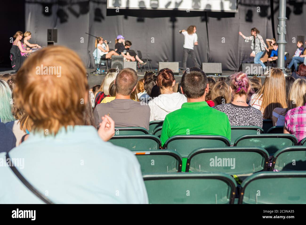 Rear view of audience at open air theatre in city center Stock Photo ...
