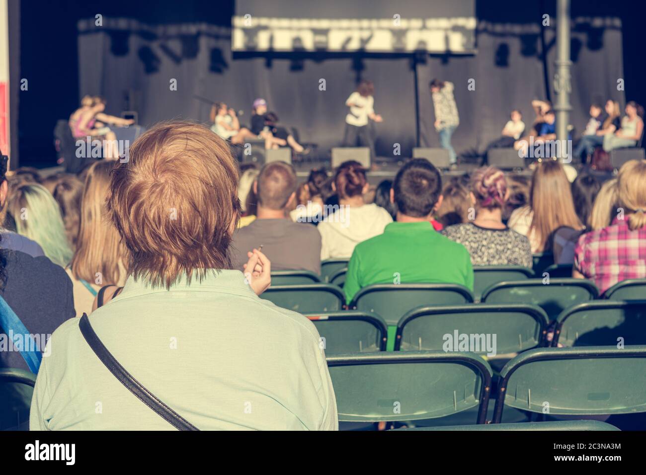 Rear view of audience at open air theatre in city center Stock Photo ...
