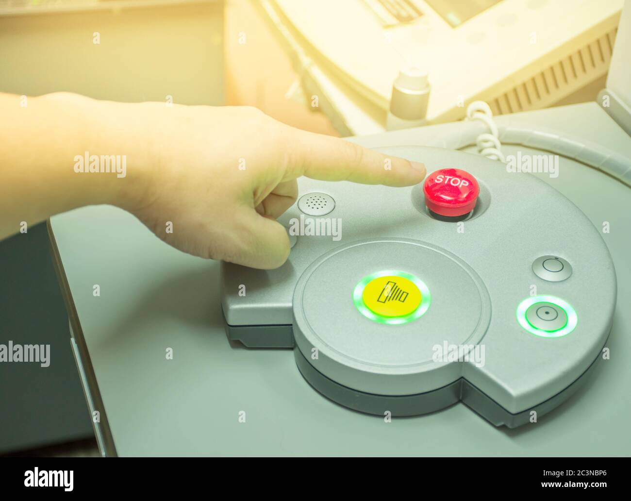 Hand pressing the red button.emergency stop button Stock Photo - Alamy
