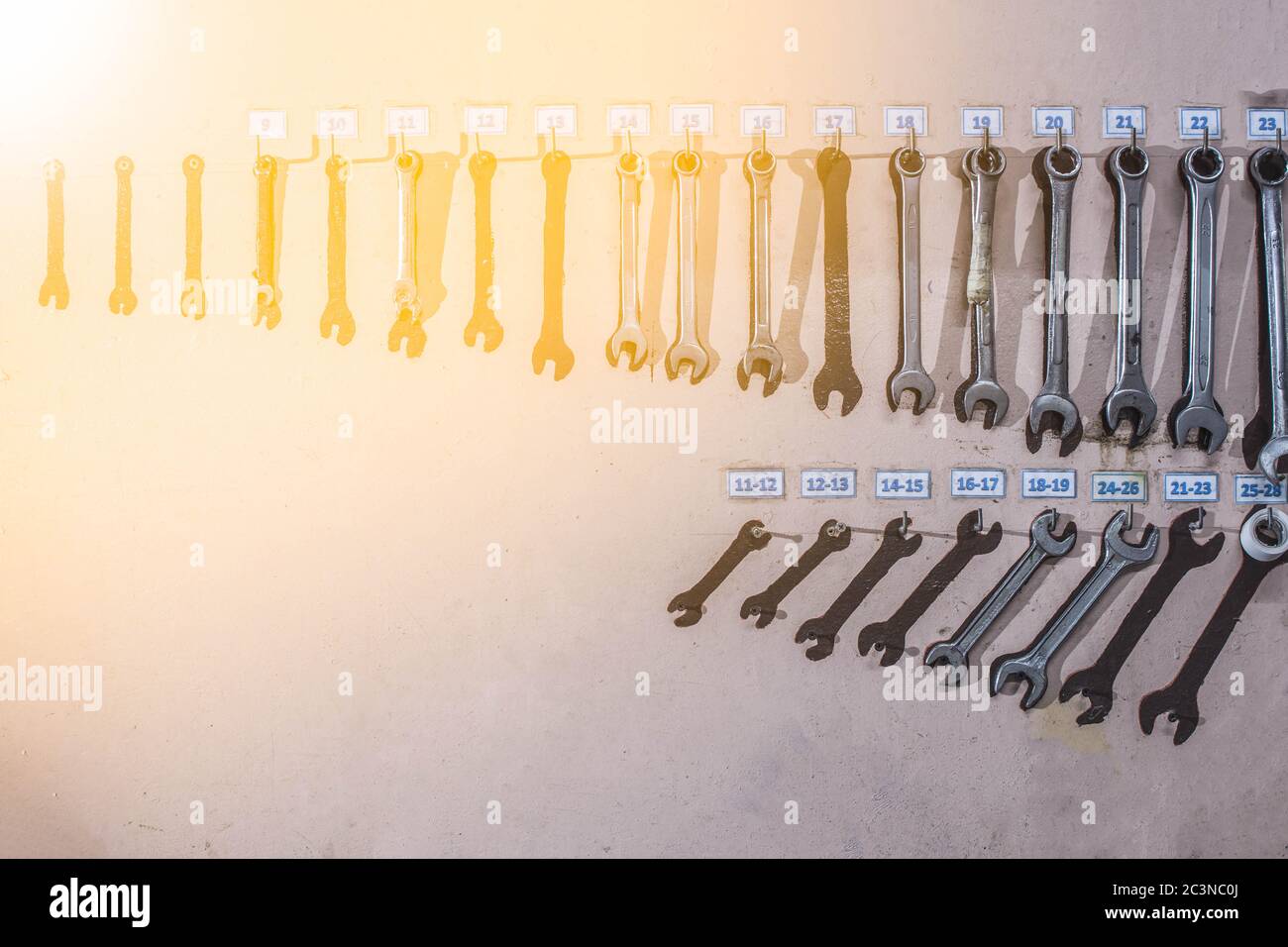 set of real used stainless spanners or wrench hanging on old wall Stock ...
