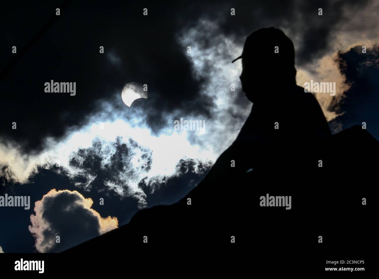 Manila. 21st June, 2020. A man looks at the partial solar eclipse in ...