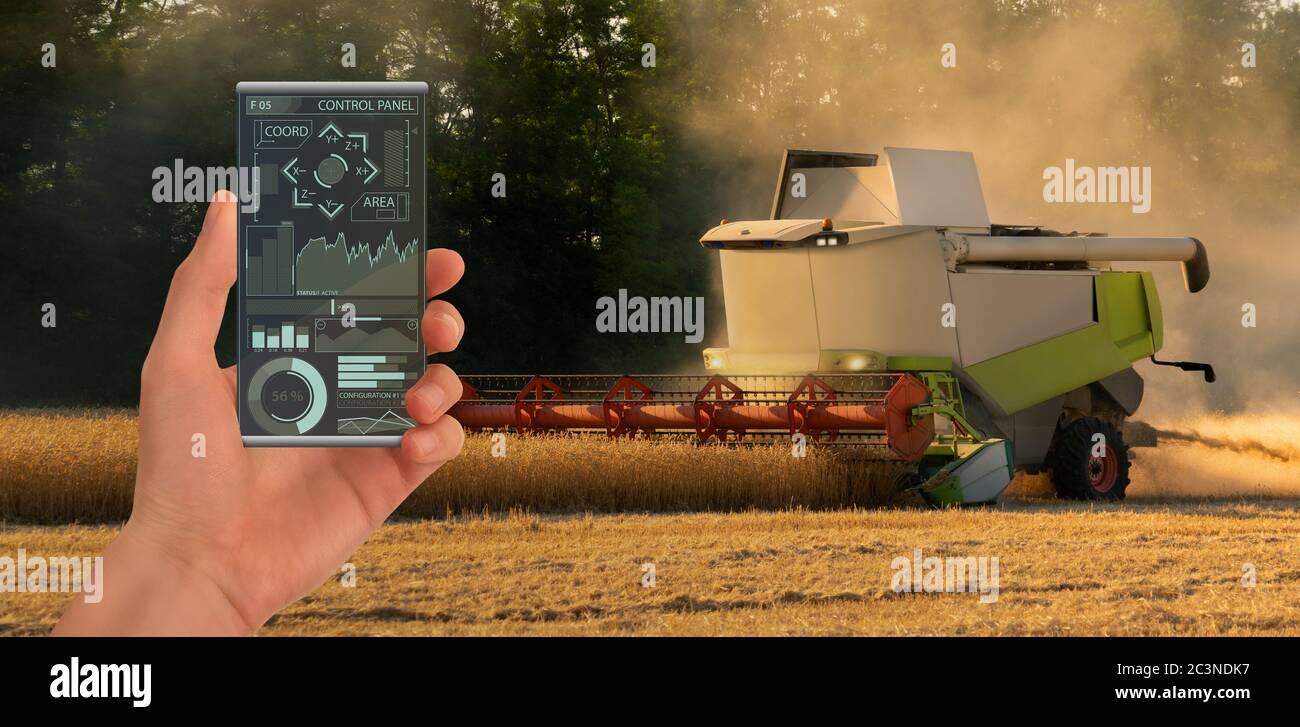 Farmer with digital tablet controls an autonomous tractor and drone on ...