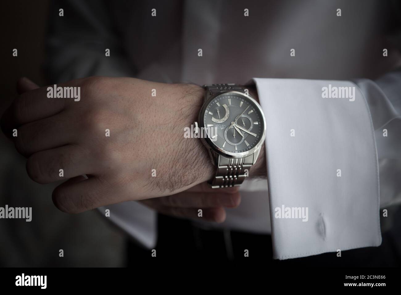 Businessman wearing a watch before going to work Stock Photo - Alamy