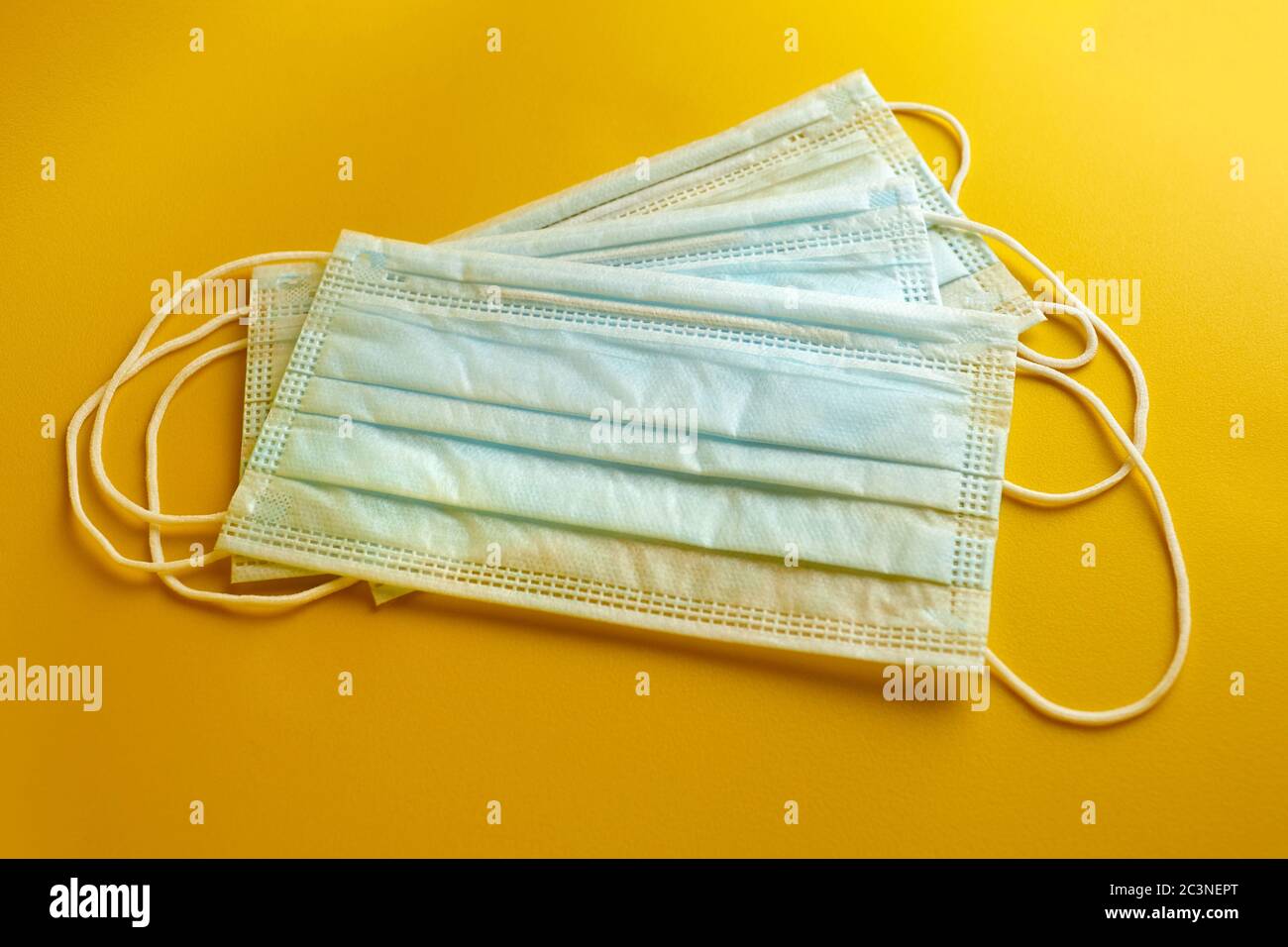 Face masks on yellow background. Medical sanitary surgical masks, anti ...