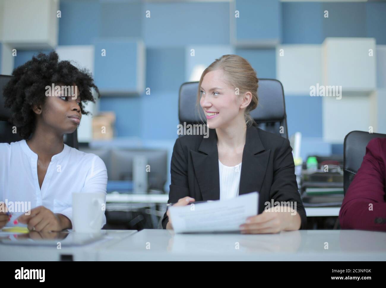 Successful female team leader in a formal outfit presenting the new ...