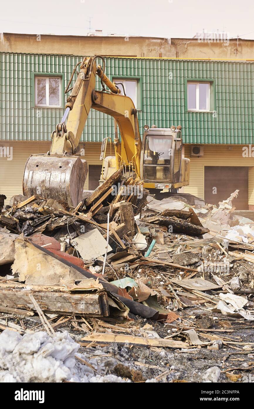 Demolition house using excavator in city. Rebuilding process. Remove ...