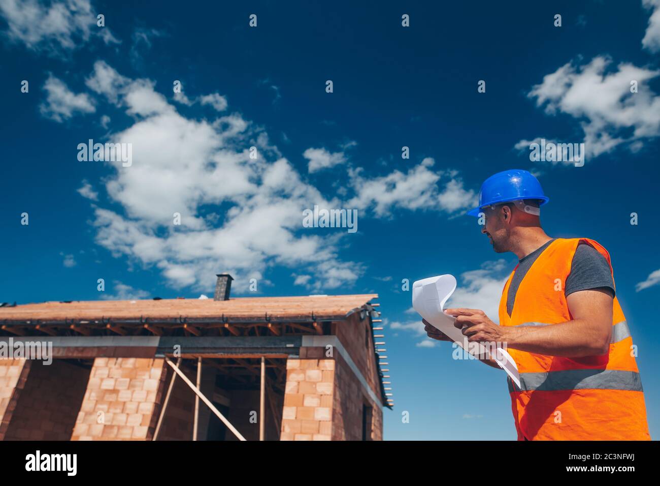 Site construction architect overseeing construction new building with ...