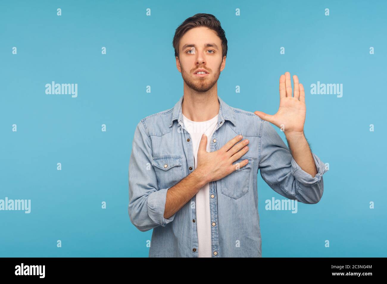 I swear! Portrait of honest responsible man in worker denim shirt ...