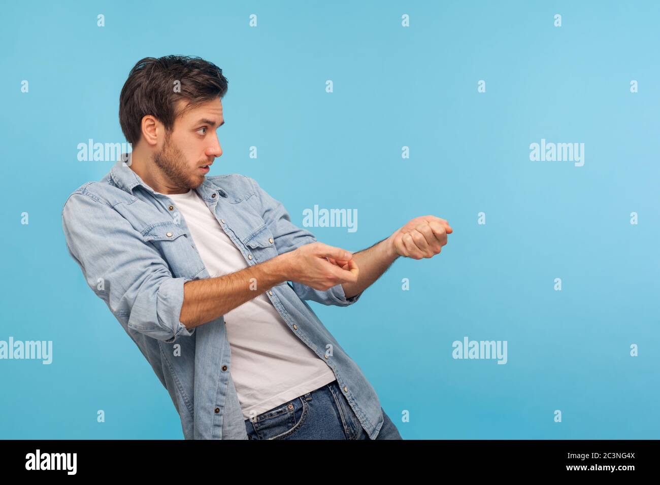 Portrait of hardworking persistent man in worker denim shirt pulling ...