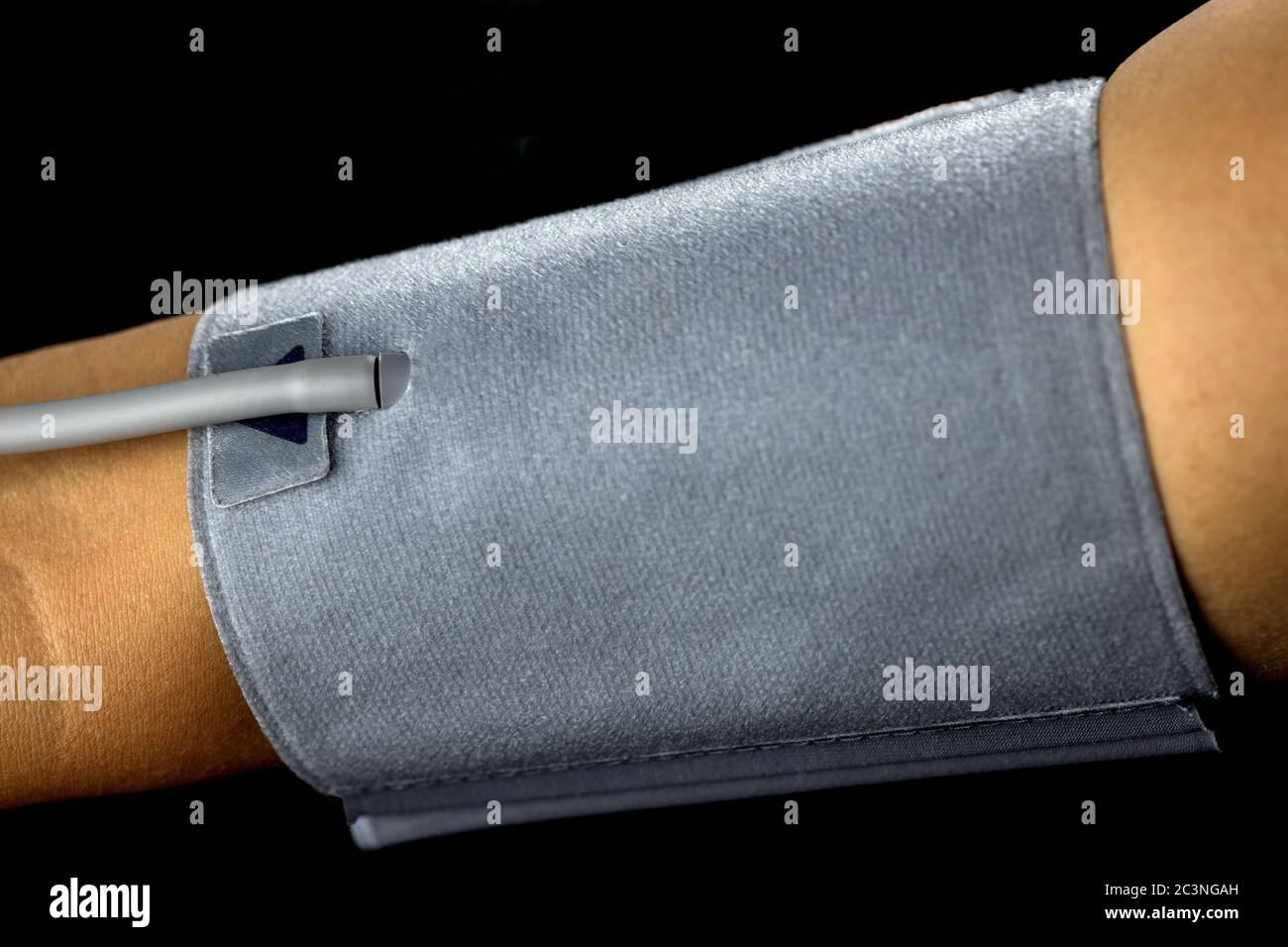 Blood pressure monitor cuff wrapped on arm close up Stock Photo - Alamy