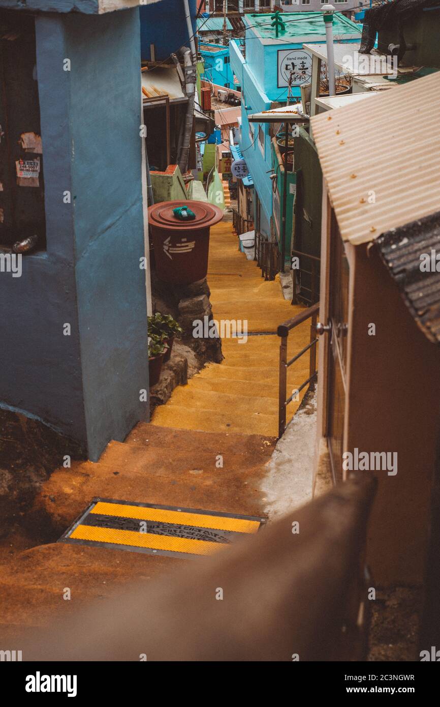 Vertical shot of a narrow alley with staircases of a city slum Stock ...