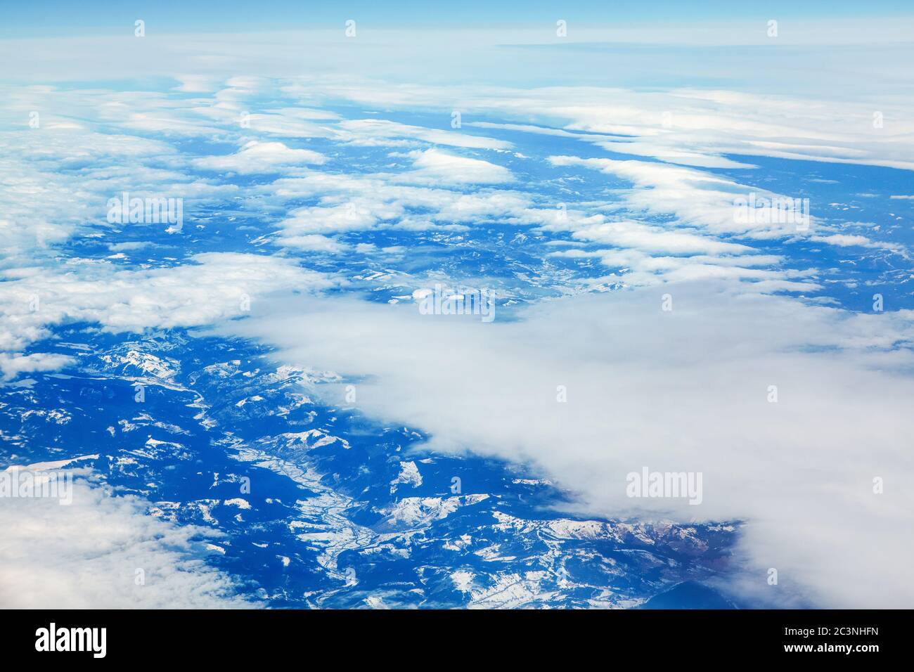 flying above clouds and snowy mountains Stock Photo - Alamy