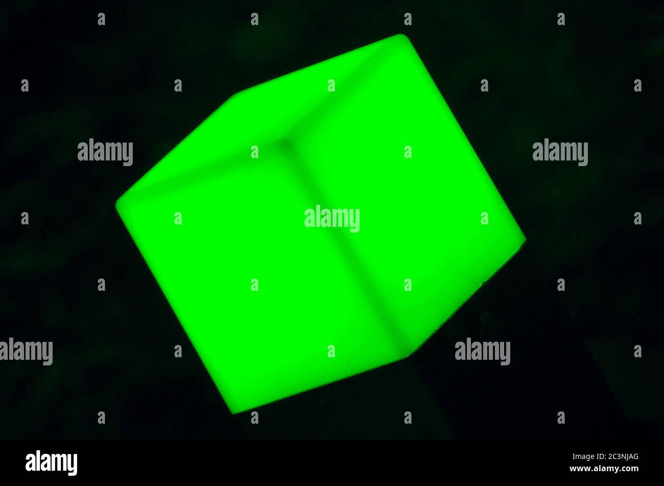 Illuminated green cube isolated on the black background Stock Photo - Alamy