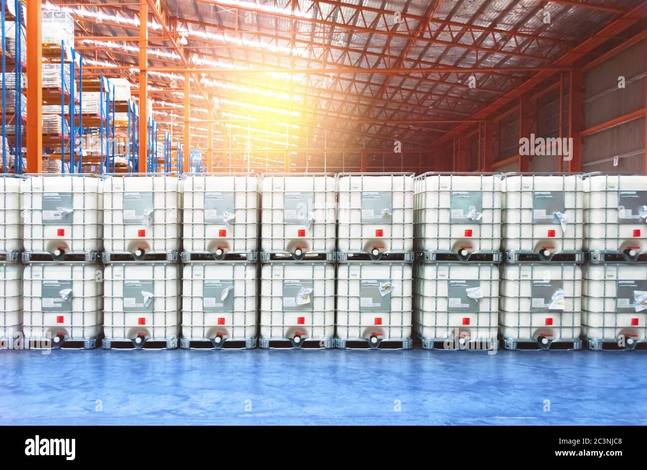 Liquid storage tank stack inside distribution warehouse. Industrial ...