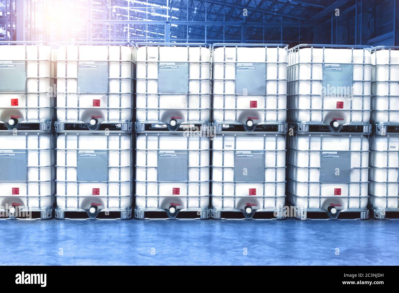 Liquid storage tank stack inside distribution warehouse. Industrial ...