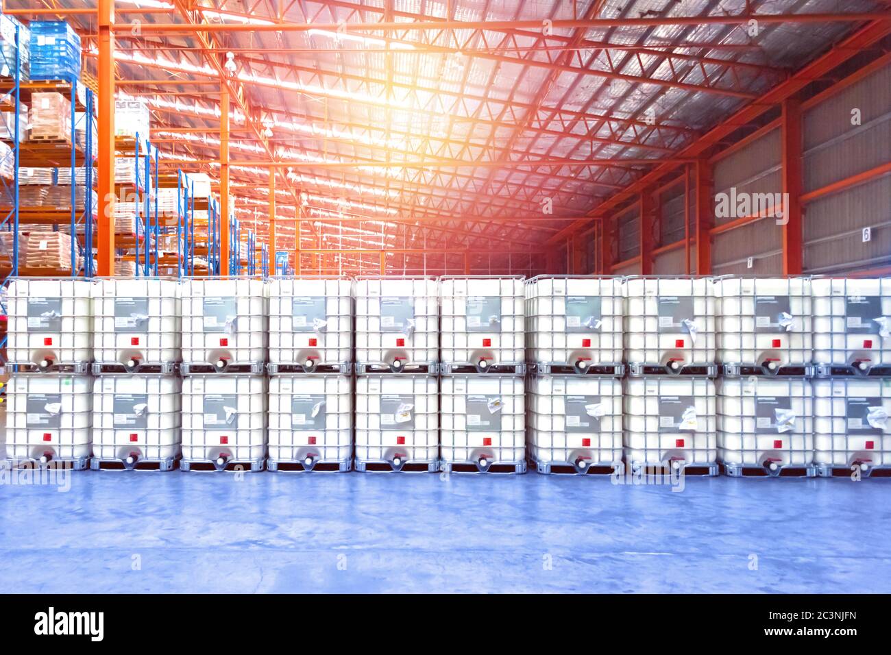 Liquid storage tank stack inside distribution warehouse. Industrial ...