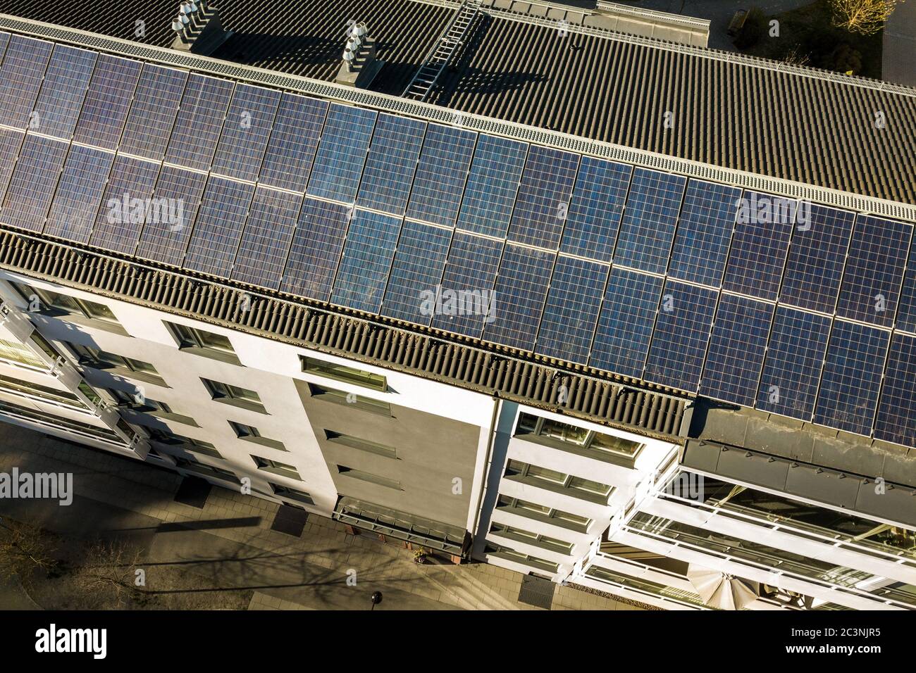 Aerial view of solar photovoltaic panels on a roof top of residential ...