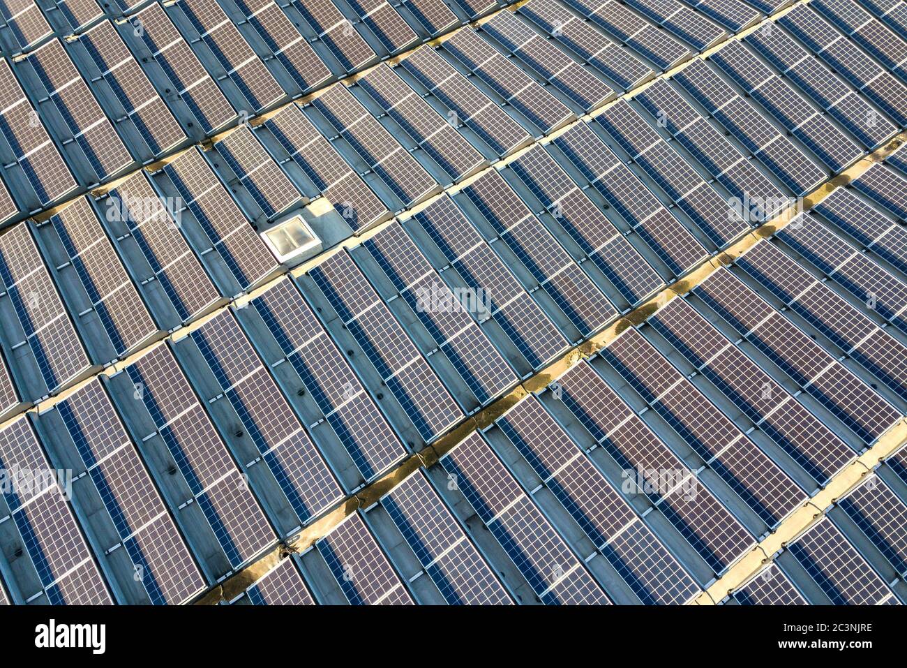 Aerial view of many photo voltaic solar panels mounted of industrial ...