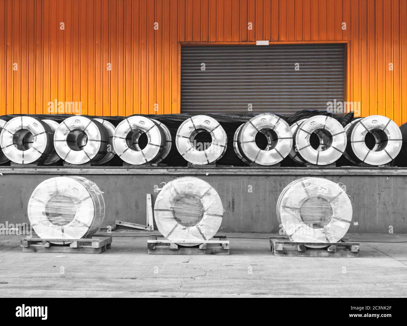 Steel coils on wooden pallets in warehouse stuffing area for container ...