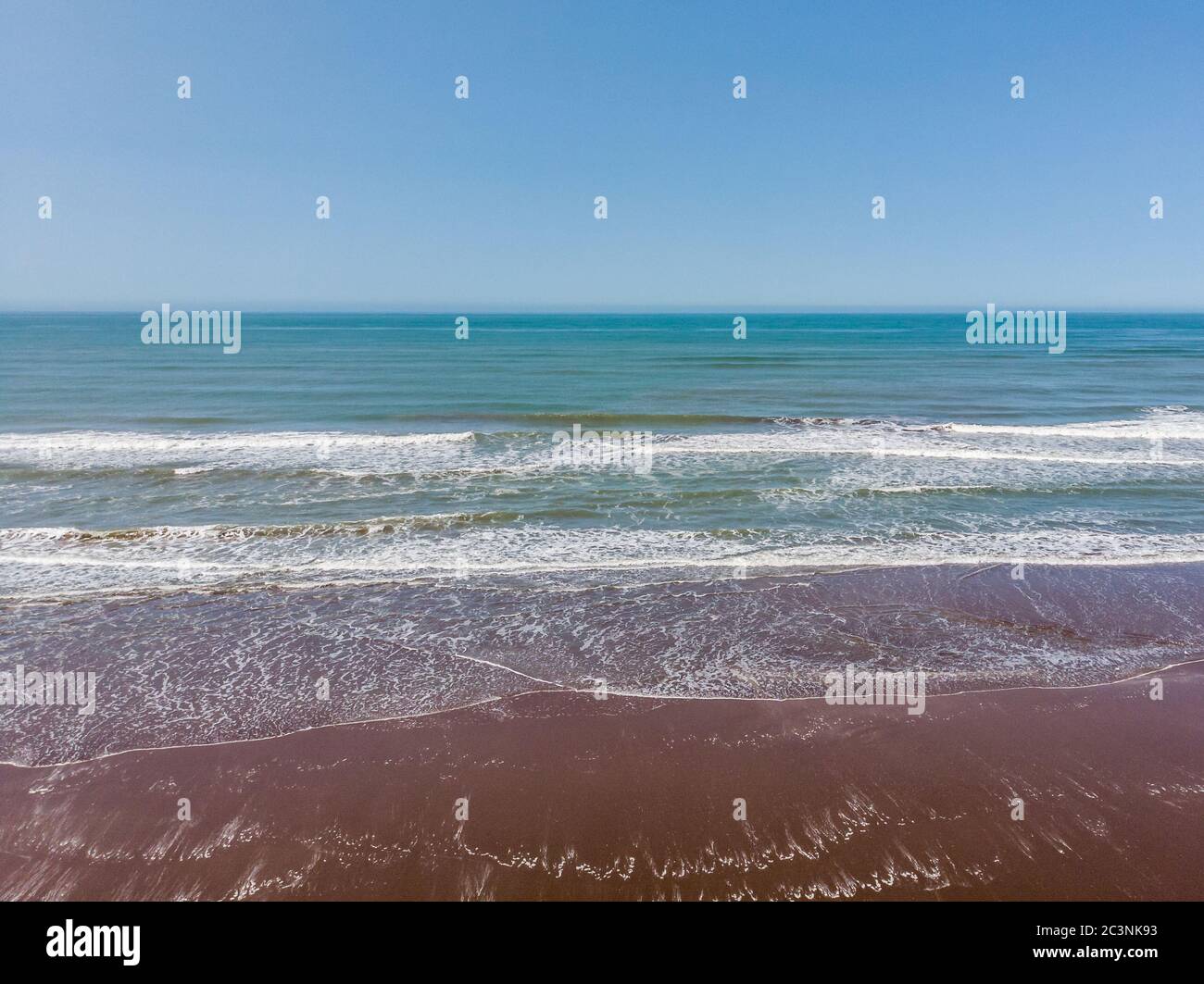 Aerial view of the sea waves from the coast to the horizon. The sky is ...