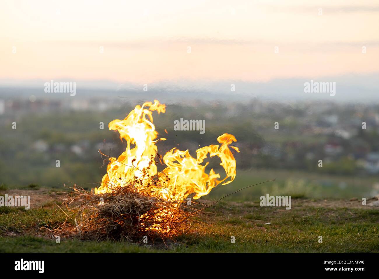 Big bright bonfire bugning at field in evening Stock Photo - Alamy