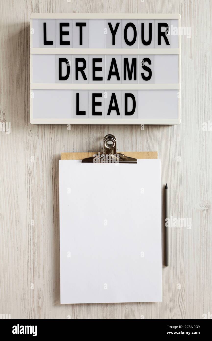 'Let your dreams lead' on a lightbox, clipboard with blank sheet of ...