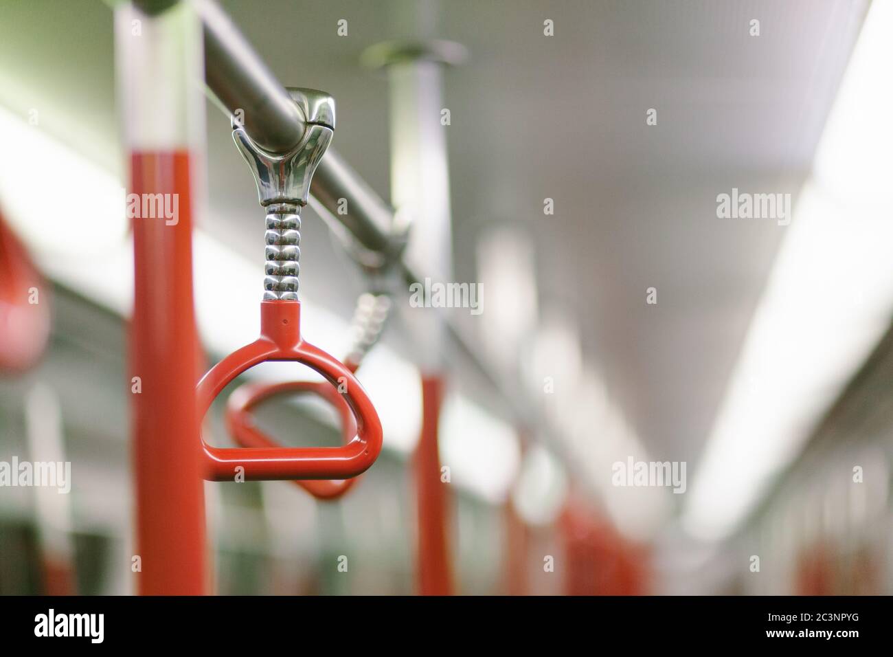 Red handrails in the subway train Stock Photo - Alamy