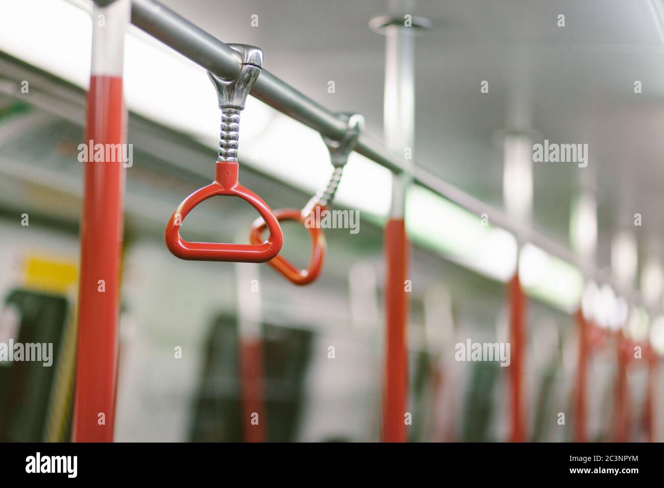 Red handrails in the subway train Stock Photo - Alamy