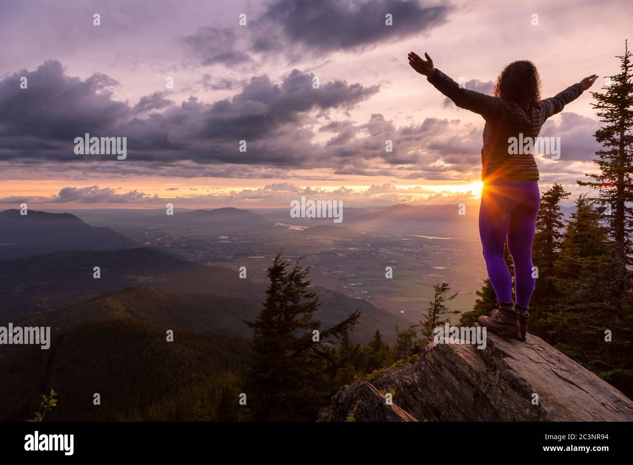 Girl on the mountain during sunset Stock Photo - Alamy