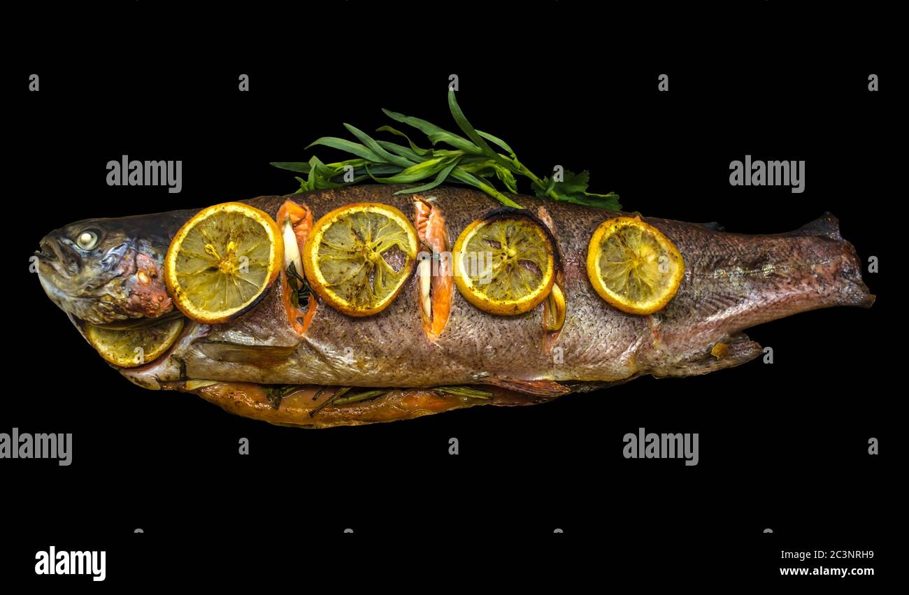 Baked delicious Trout stuffed with herbs and spices, covered with lemon ...