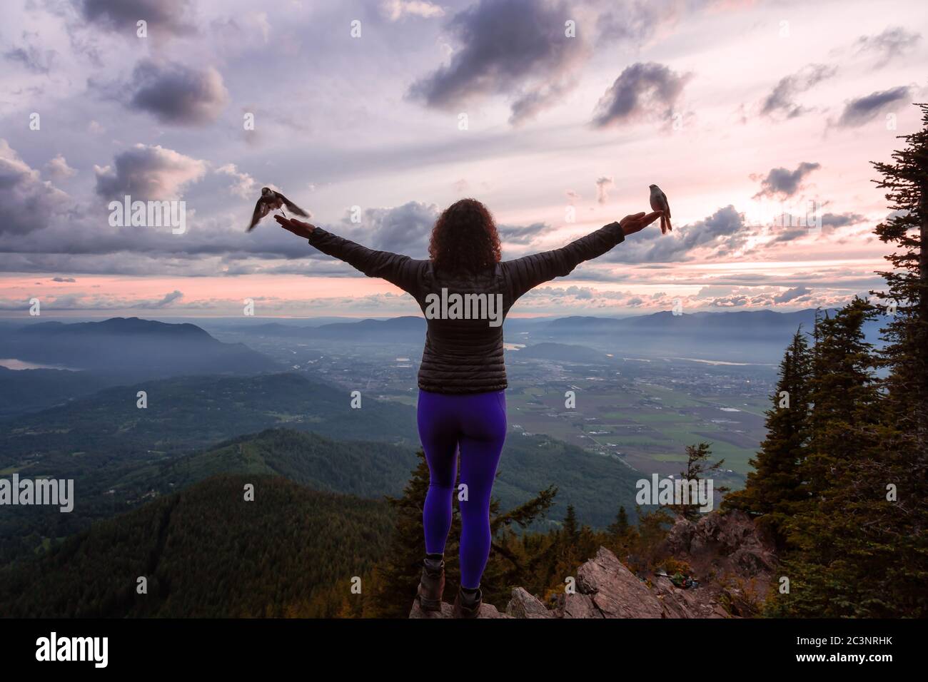 Girl on the mountain during sunset Stock Photo - Alamy