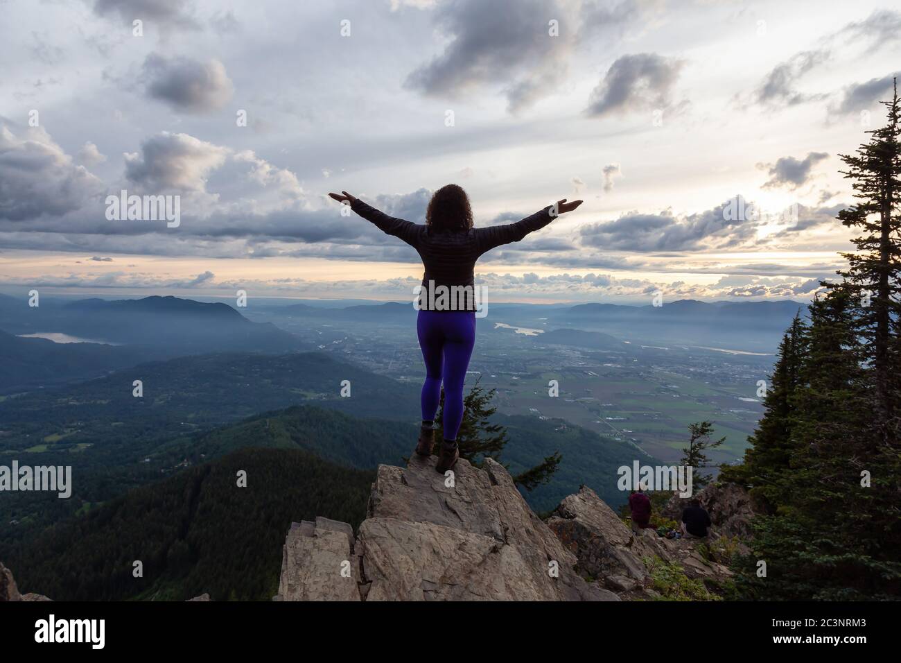 Girl on the mountain during sunset Stock Photo - Alamy