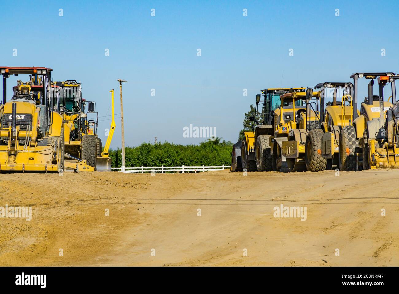 A lineup of heavy equipment parked for the weekend at the re-route of ...