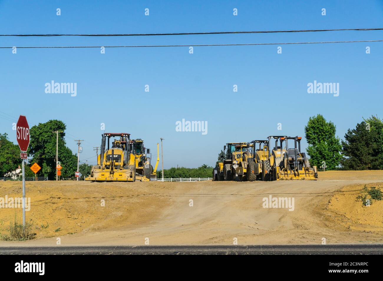 A lineup of heavy equipment parked for the weekend at the re-route of ...
