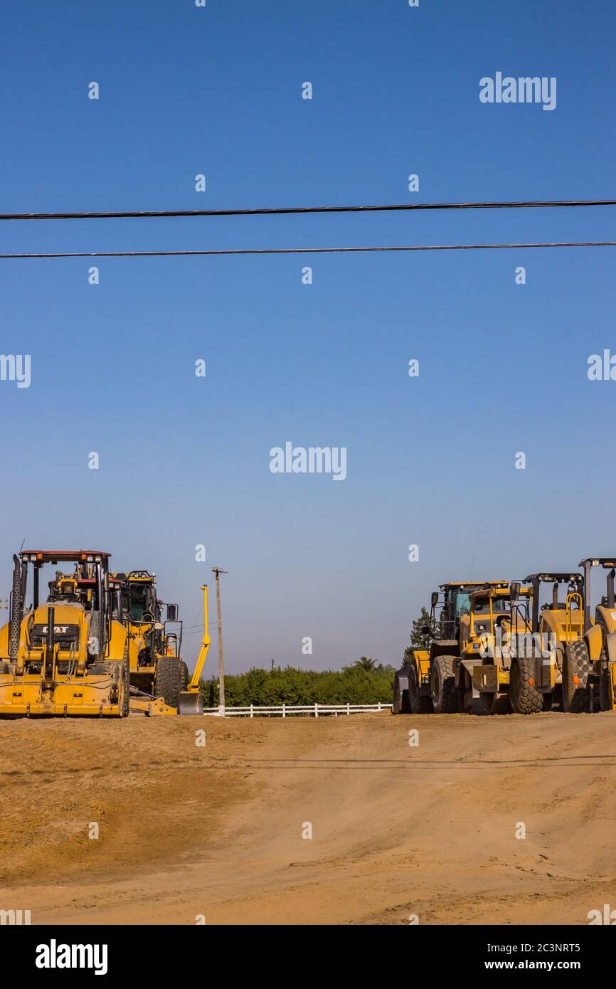 A lineup of heavy equipment parked for the weekend at the re-route of ...