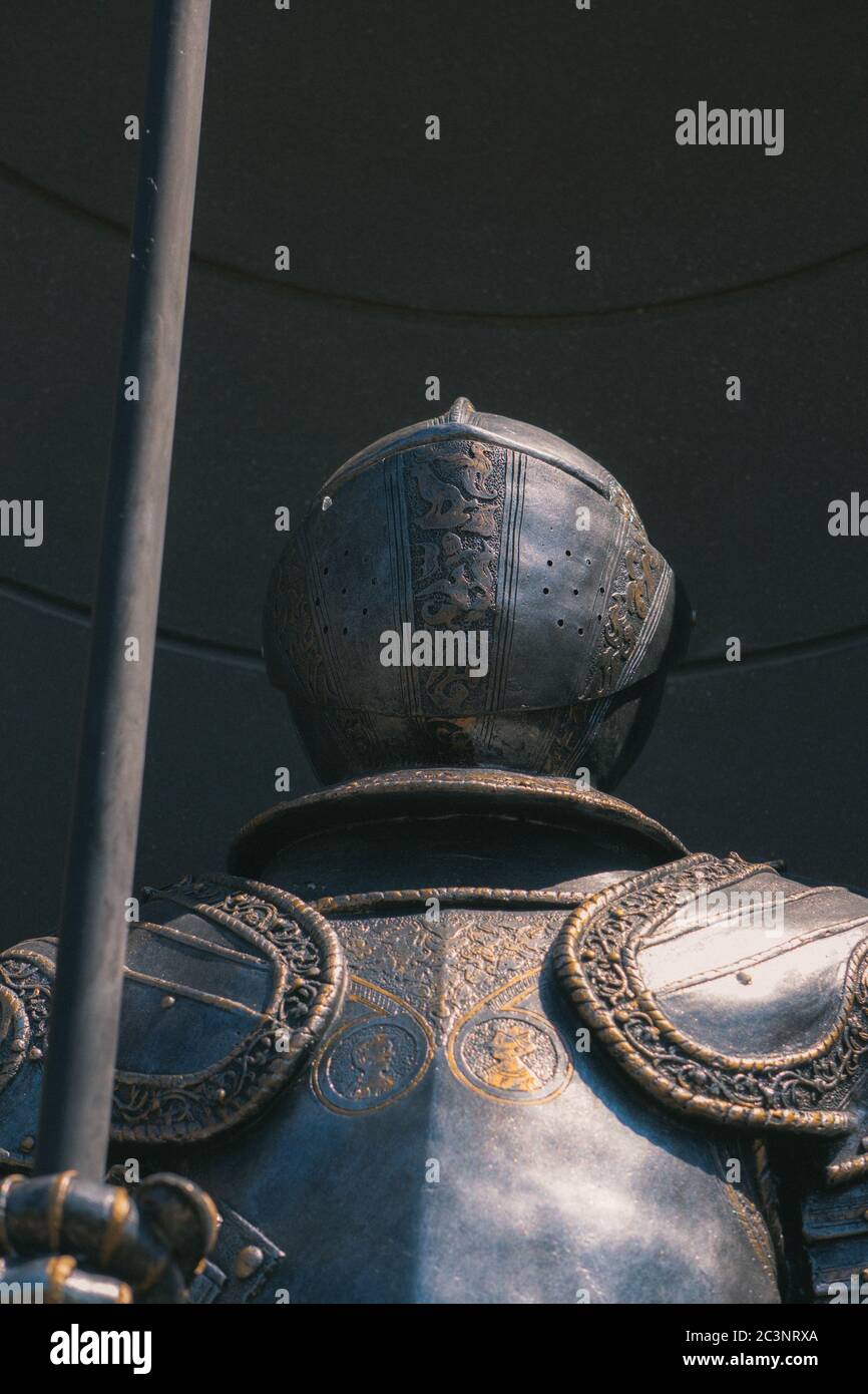 Vertical low angle shot of armor of a military soldier on a grey ...