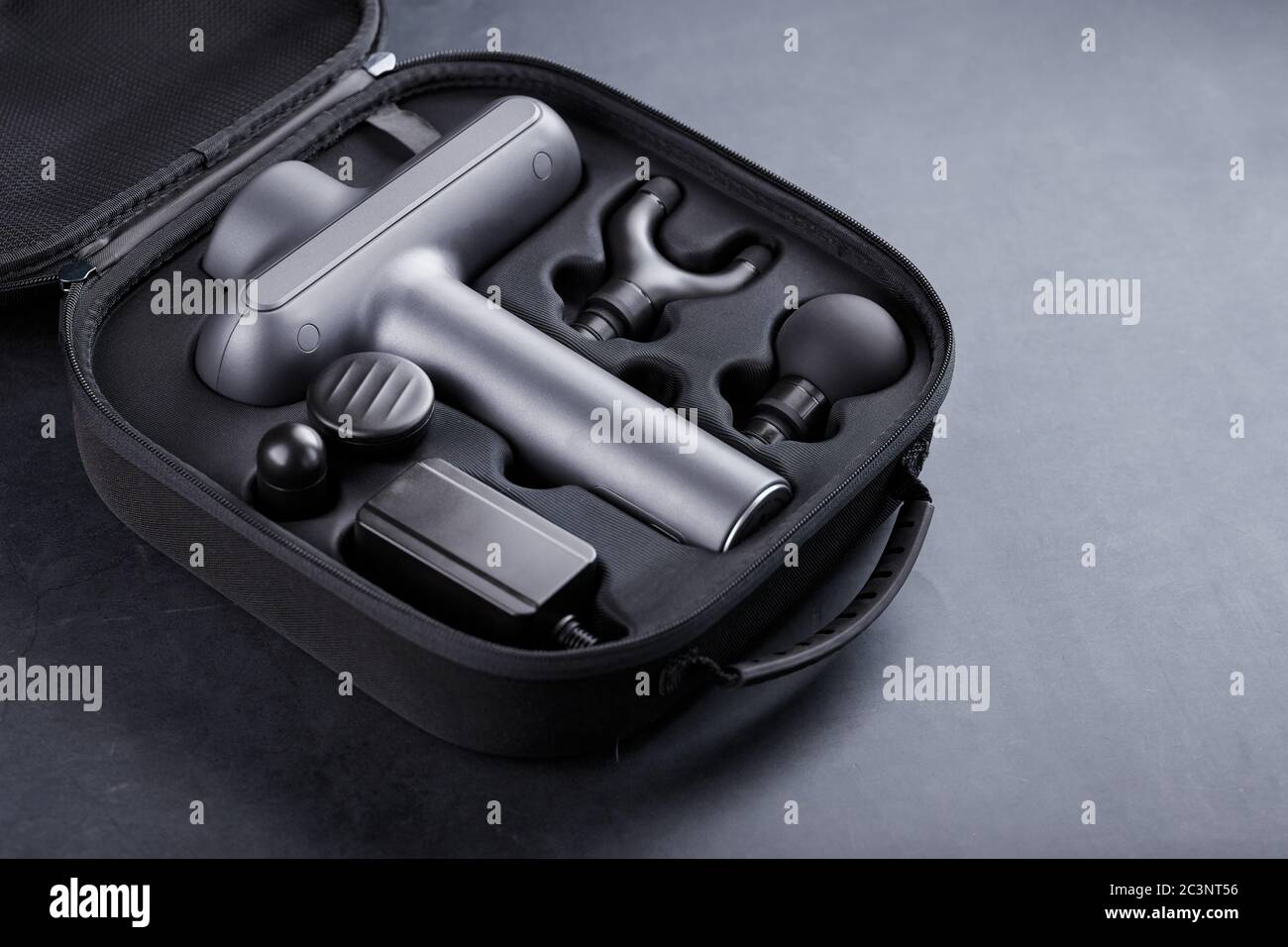 Electric massager Machine for body massage in a case on a black ...