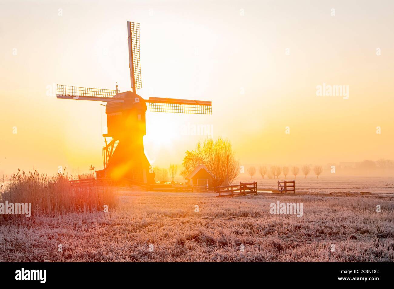 Windmill silhouettes at the early morning sunrise Stock Photo - Alamy