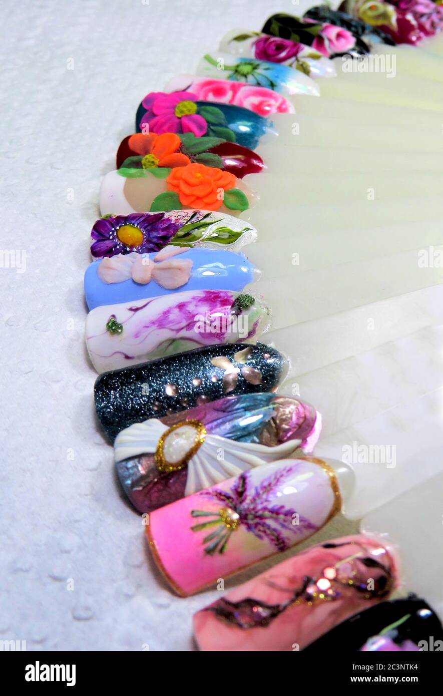 Vertical closeup shot of samples of various fingernail designs isolated ...