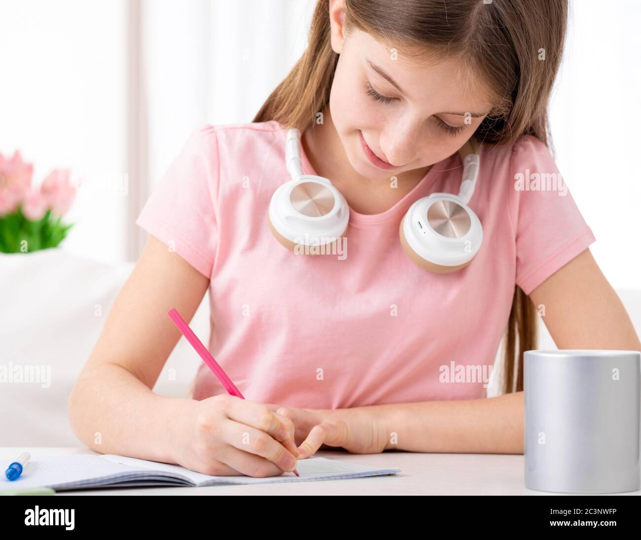 Pretty school girl making homework at home Stock Photo - Alamy
