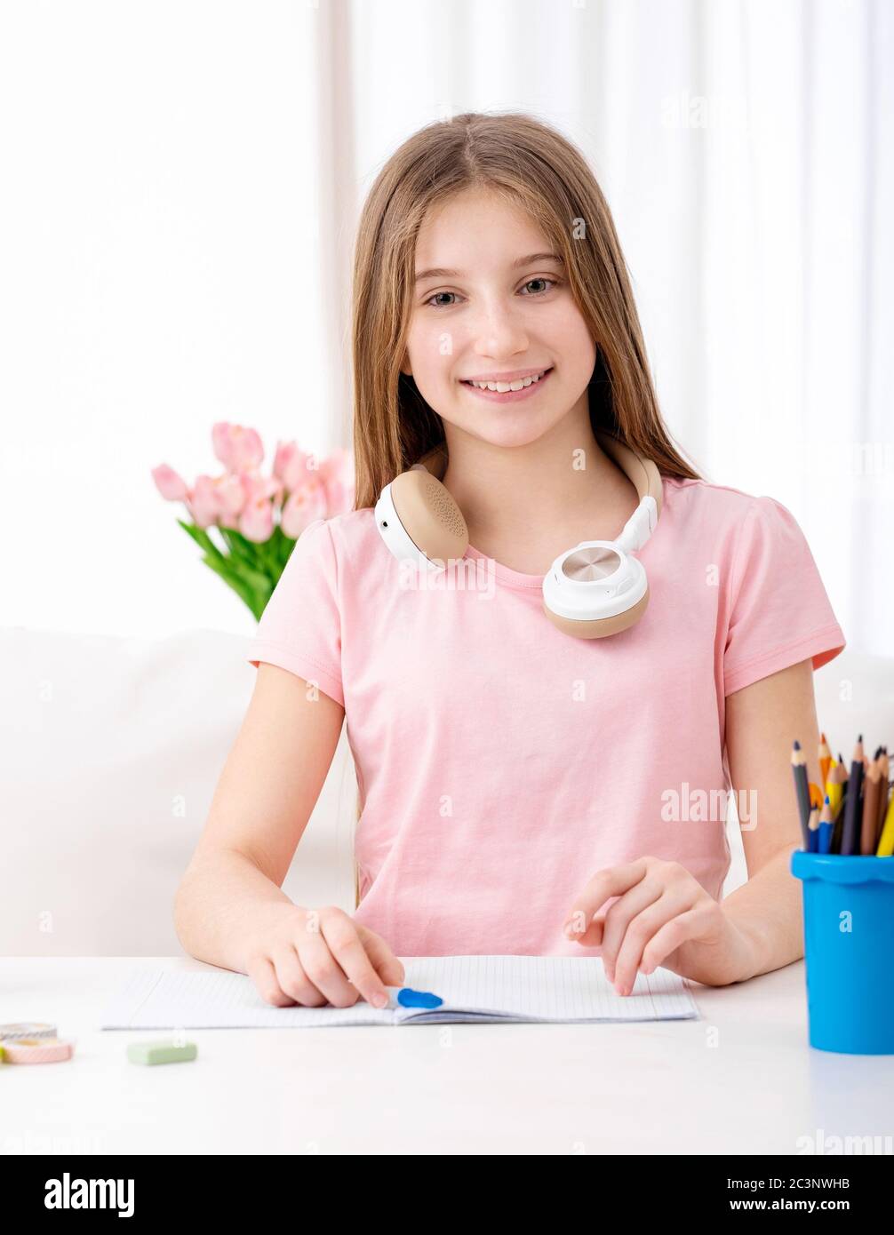 Pretty young girl learning with headphones Stock Photo - Alamy