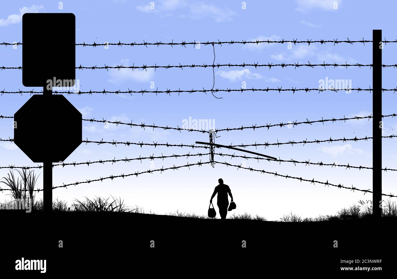 A man is seen in silhouette after breaching a border fence on the ...