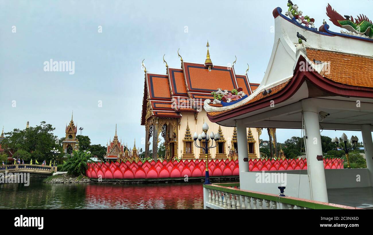 Asian style temple standing on the lake. Multi colored buildings and a ...