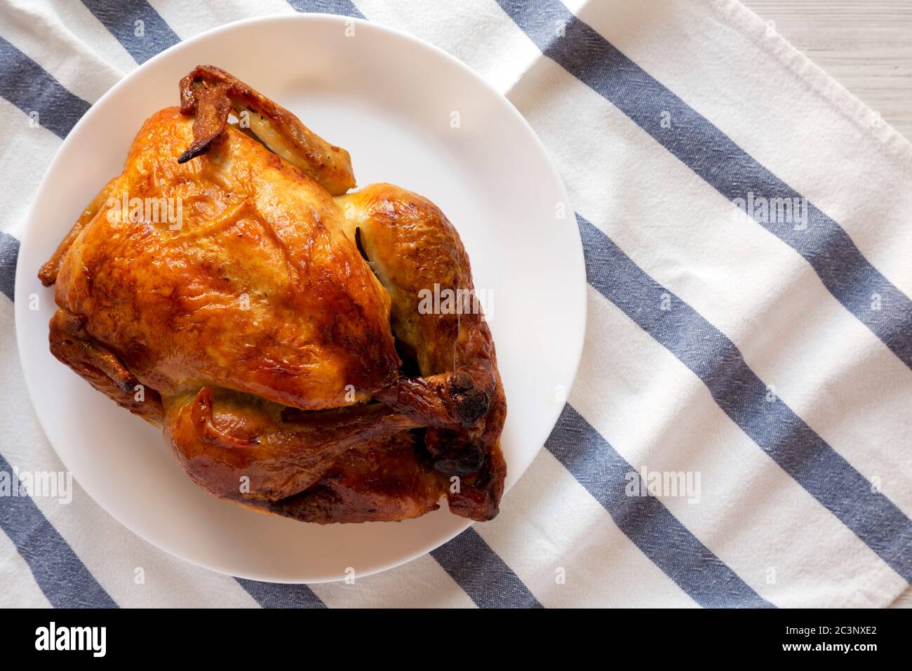 Homemade traditional rotisserie chicken on a white plate, top view ...
