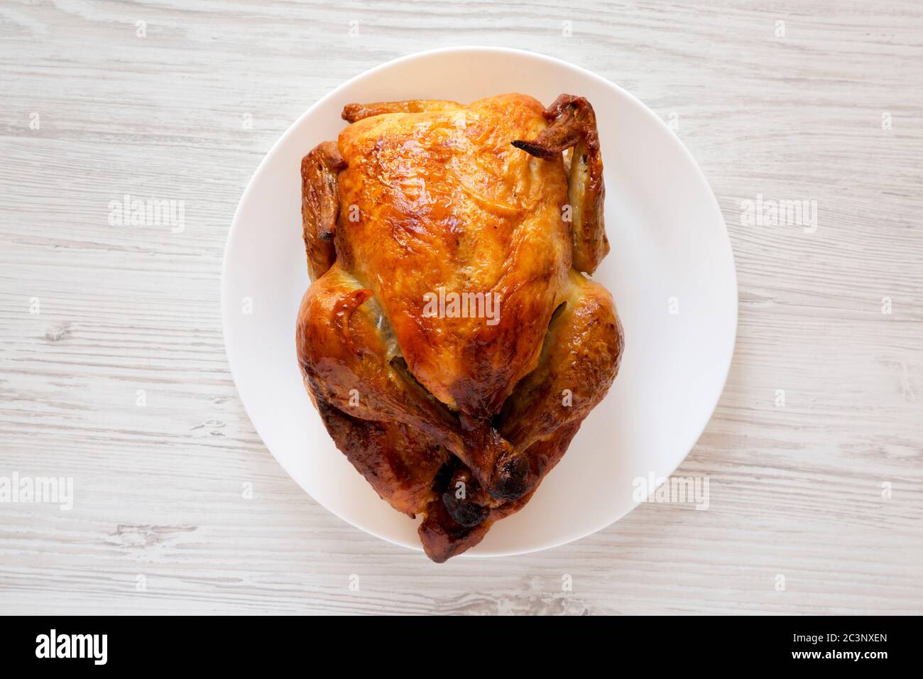 Homemade traditional rotisserie chicken on a white plate, top view ...