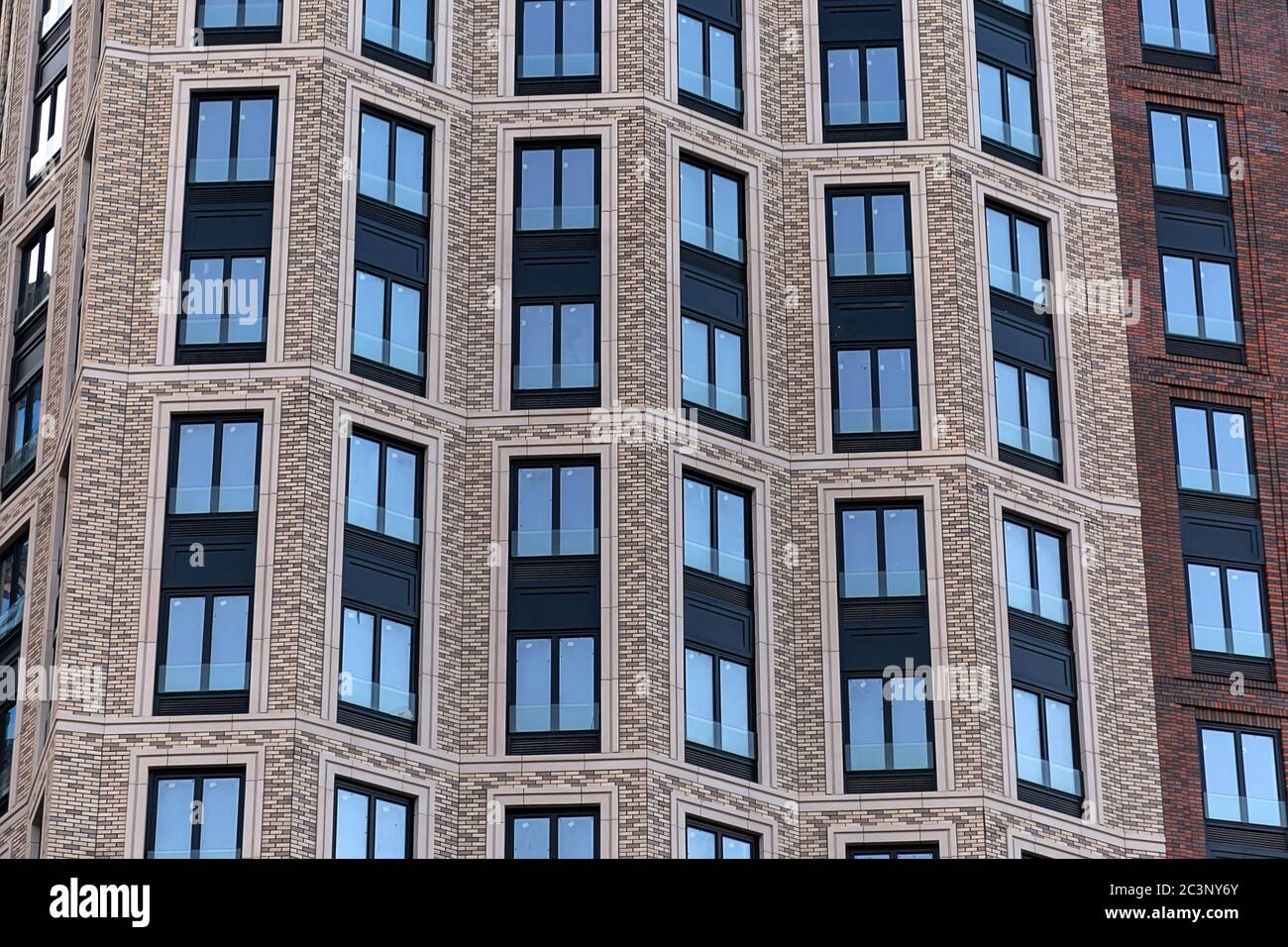 Colorful Brick wall of a skyscraper with windows Stock Photo - Alamy