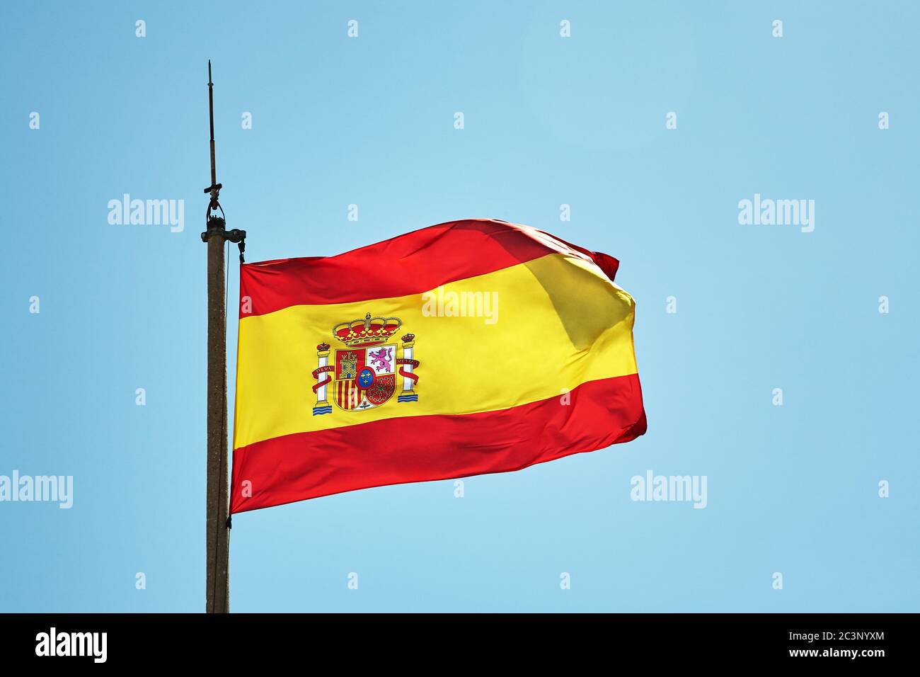 Spanish flag flying on a flagpole on sky background Stock Photo - Alamy