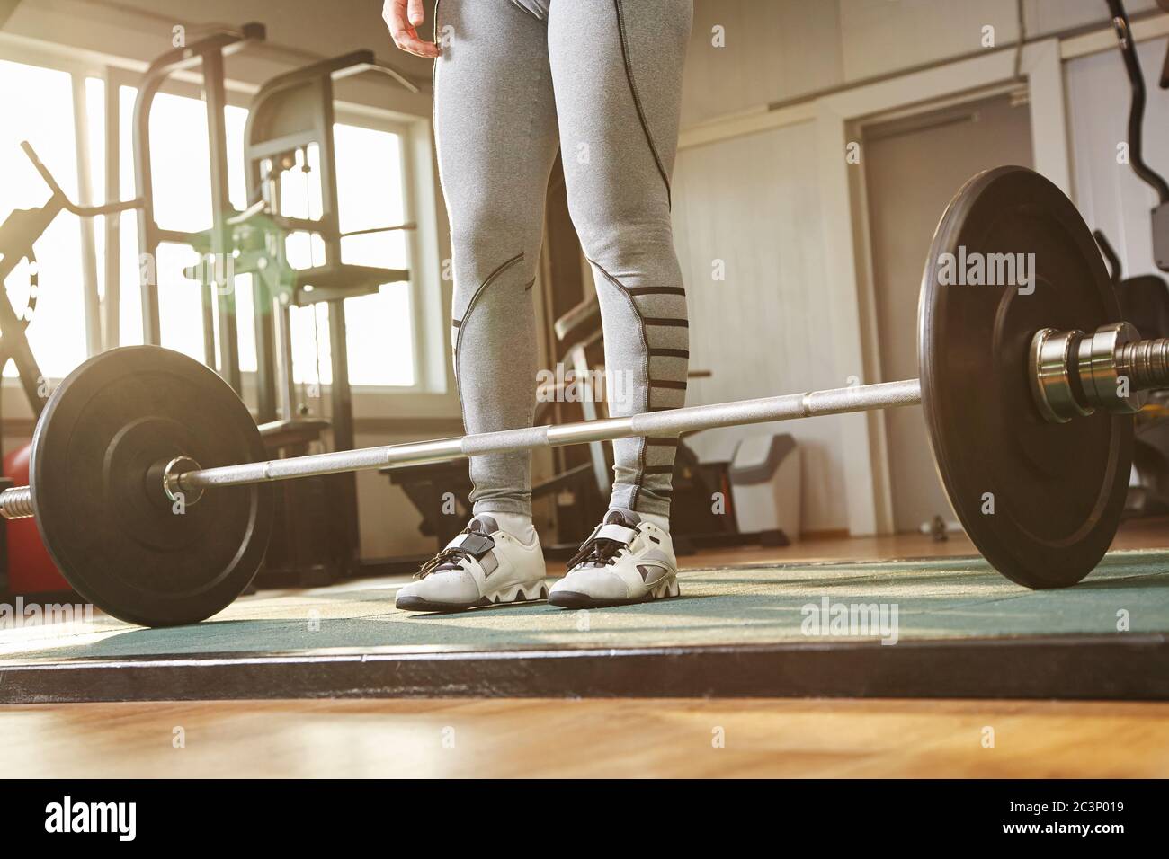 closeup legs of a sports woman training with a barbell in a gym Stock ...
