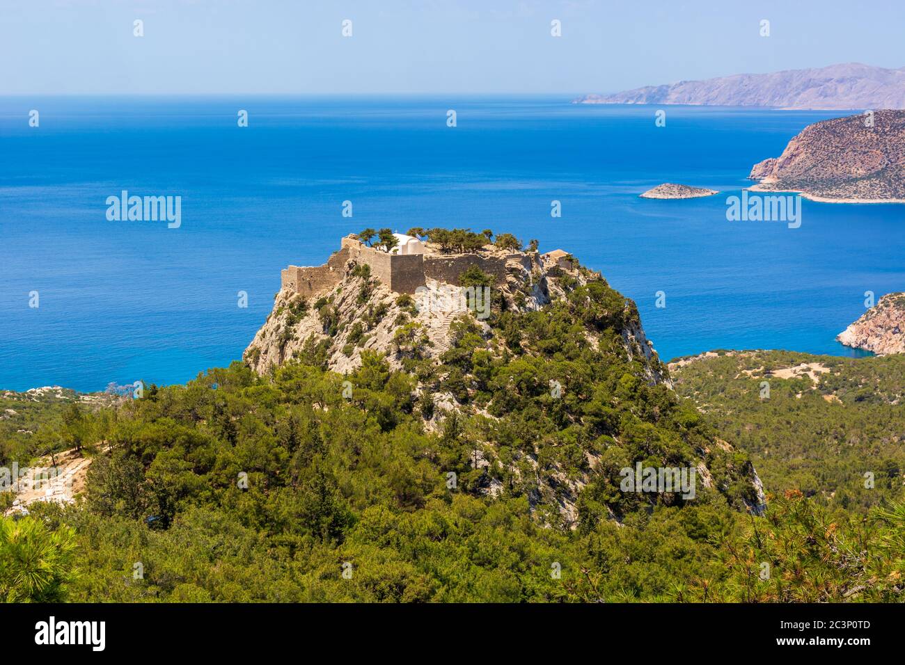 The castle of Monolithos located at the summit of the tall rock. Rhodes ...