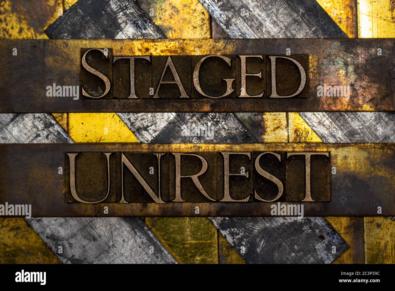 Staged Unrest text formed with real authentic typeset letters on ...